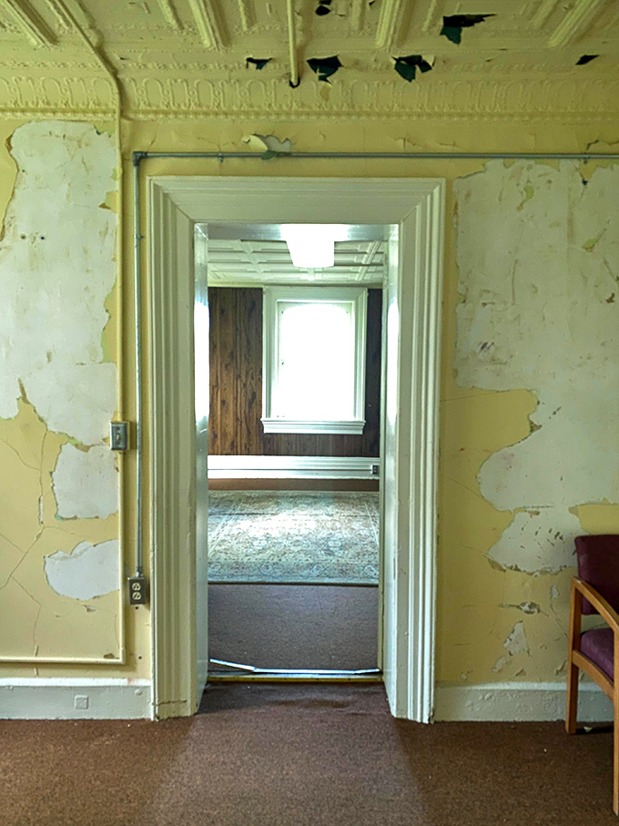 Doorways within doorways create an optical illusion of infinite regression, much like the building's layered history of care and confinement.