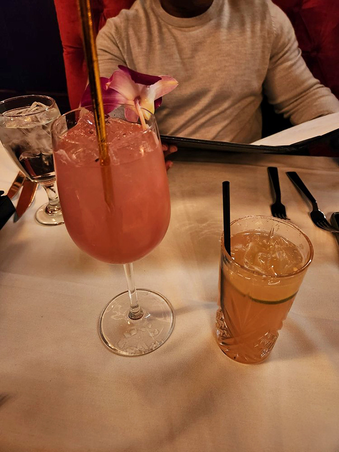 Cocktails that dress better than most people. That pink beauty isn't just a drink &ndash; it's a conversation starter with a flower crown.