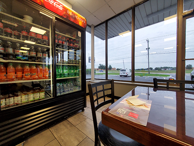 The beverage cooler stands ready, knowing full well that greatness between bread demands proper hydration.