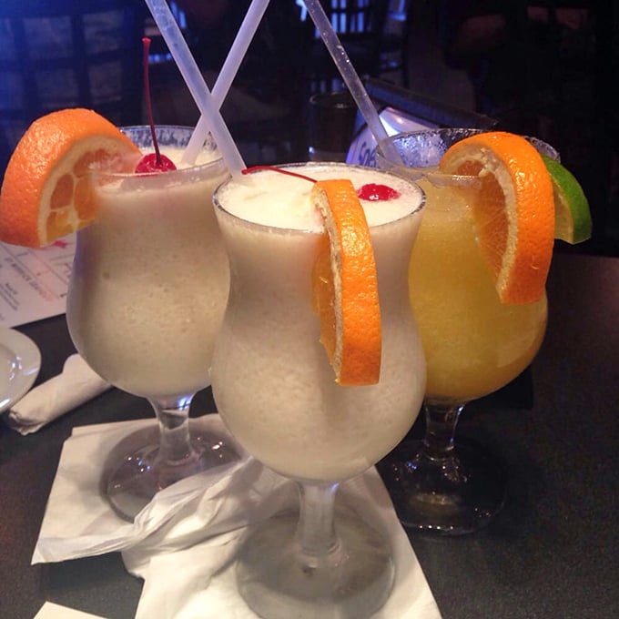 Tropical cocktails that transport you to island time with just one sip. Those orange spirals aren't just garnish&mdash;they're exclamation points on liquid vacation.