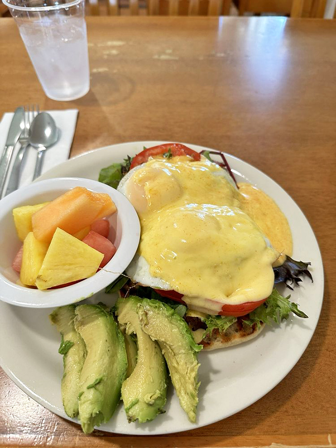 Eggs Benedict swimming in hollandaise sauce, because if you're going to do brunch, you might as well do it right.