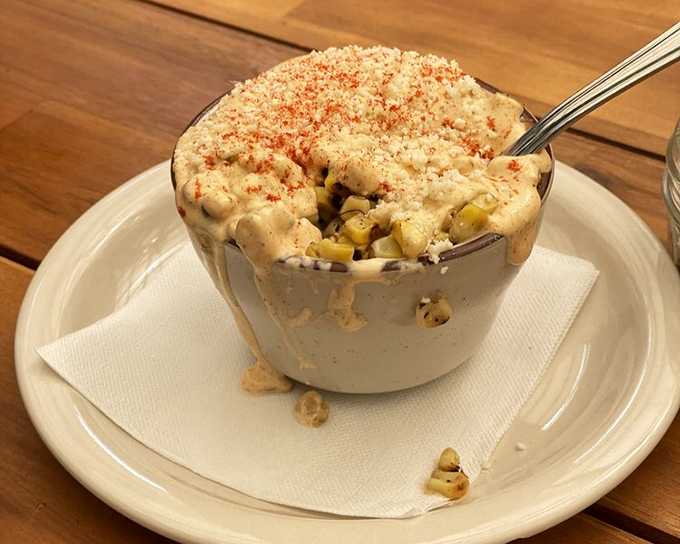 Elote in a cup with a side of comfort&mdash;proof that sometimes the simplest dishes deliver the most complex flavors.