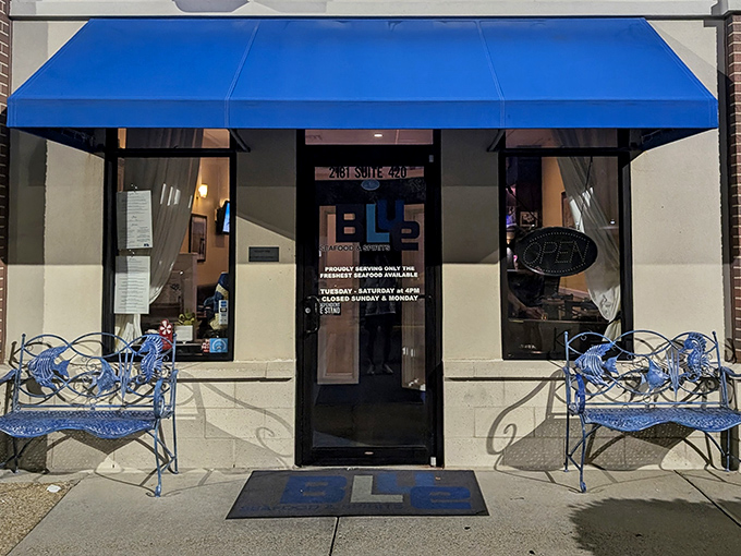 The blue benches outside invite you to pause before entering a world where Virginia's waters meet culinary magic.