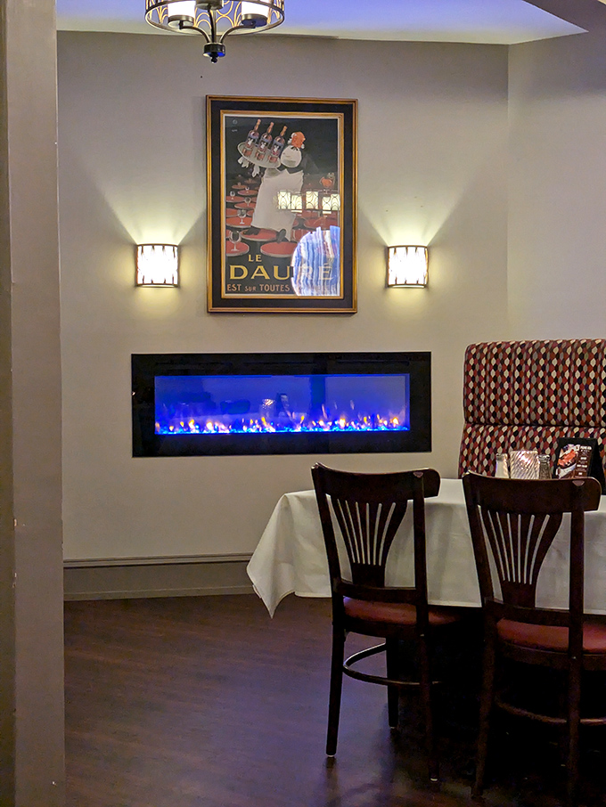 A fireplace and vintage poster create the perfect backdrop for pretending you're a sophisticated character in a classic film.