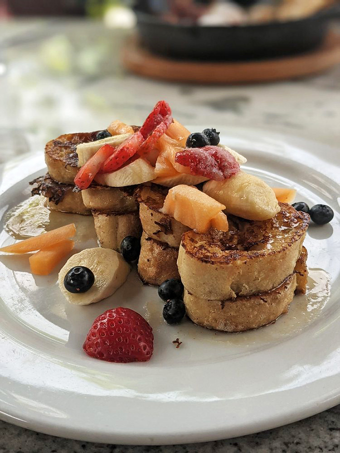 This isn't ordinary French toast&mdash;it's a breakfast masterpiece adorned with fresh berries and bananas that would make any brunch enthusiast weak at the knees.