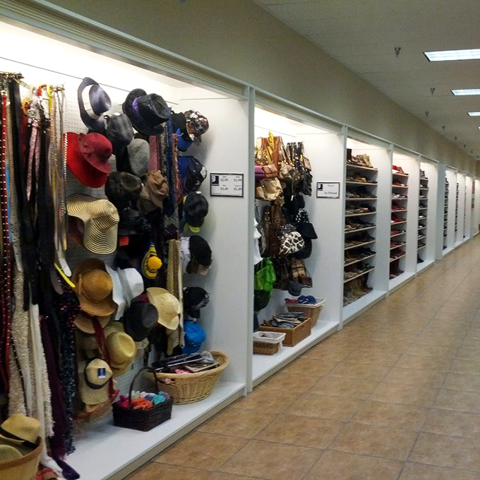 The accessories wall: where statement hats, practical bags, and forgotten fashion trends await their triumphant return to society.