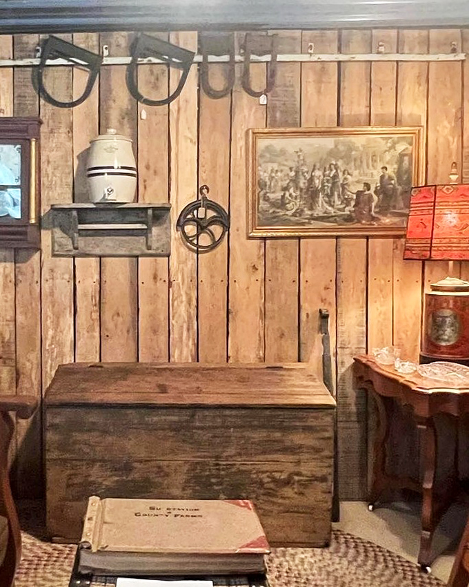 Rustic wooden walls showcase everyday tools that built America. That wooden chest has probably held everything from grain to family secrets. 