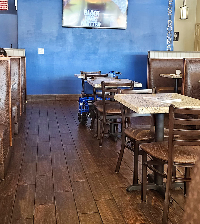 Blue walls and wooden floors create the perfect canvas for breakfast masterpieces. Simplicity with a side of style.