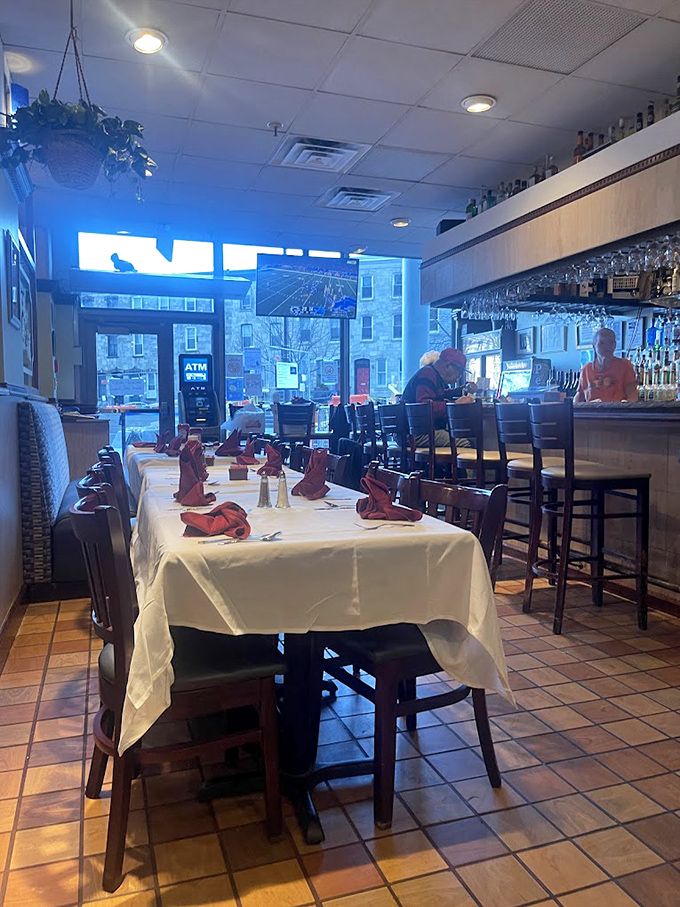 Where food meets fellowship. The white tablecloth suggests something special, while the bar in the background promises post-meal conviviality.