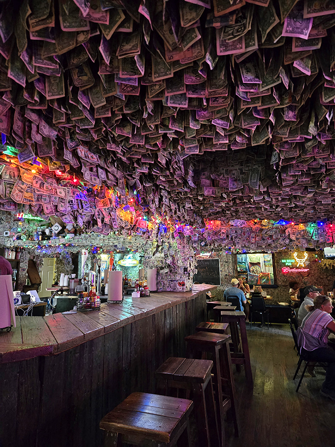 The dollar-bill decor glows under string lights like a cave of currency wonders&mdash;each bill a story, each signature a memory made.