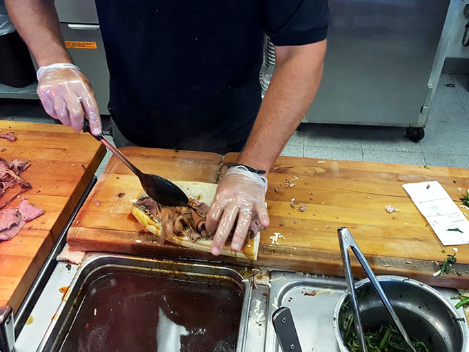 Behind the scenes where dreams are made. The flat-top grill sizzles with potential as ingredients transform into legendary sandwiches.