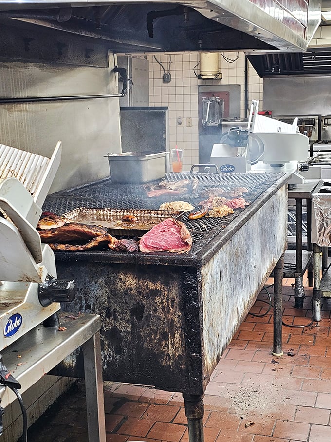 Behold the pit &ndash; that smoky, well-seasoned altar where meat transforms from ordinary to extraordinary. This isn't cooking; it's alchemy with fire and time.