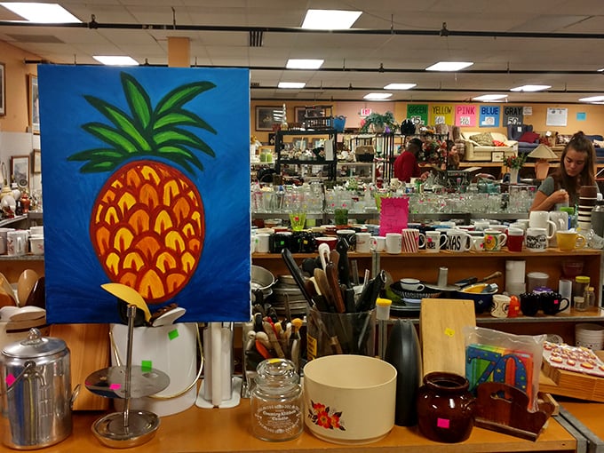 The vibrant pineapple painting adds a pop of whimsy among practical kitchen finds. Art and function coexist beautifully in the housewares section.
