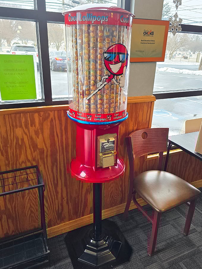 The lollipop machine&mdash;childhood nostalgia standing guard by the exit, ensuring even full-grown adults leave with a smile and maybe a treat.