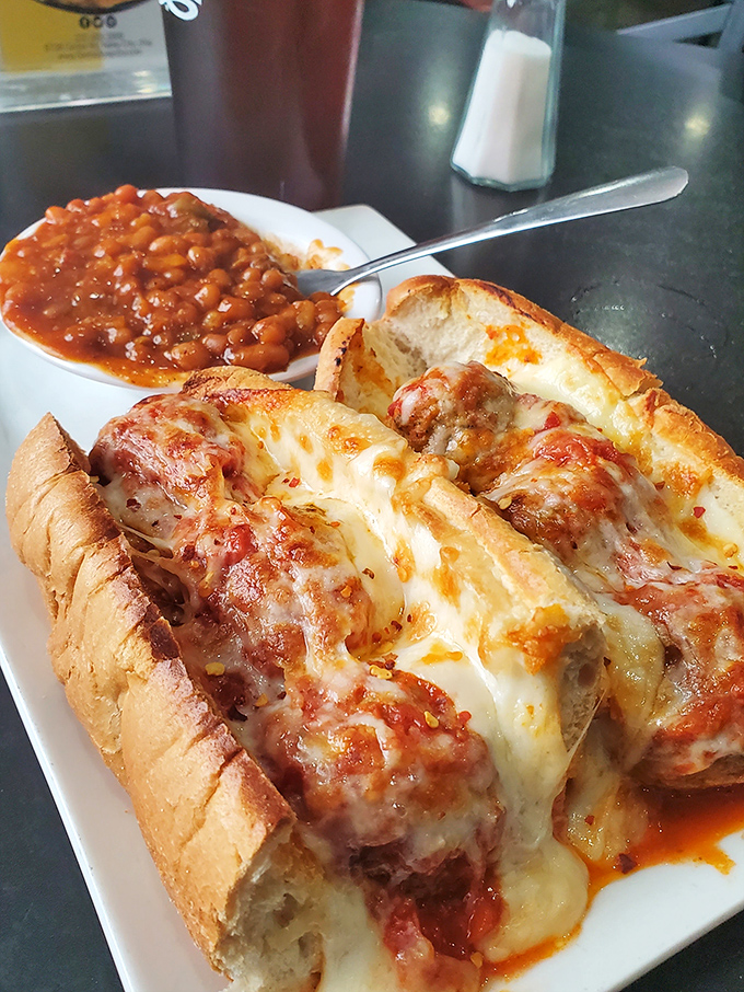 This meatball sub isn't just a sandwich&mdash;it's an engineering marvel of melted cheese, marinara, and perfectly seasoned meatballs. The side of baked beans is a bonus.
