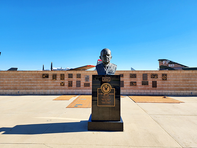 A bronze bust stands sentinel among memorial plaques, honoring those who transformed March Field from a training ground to a cornerstone of American air power.
