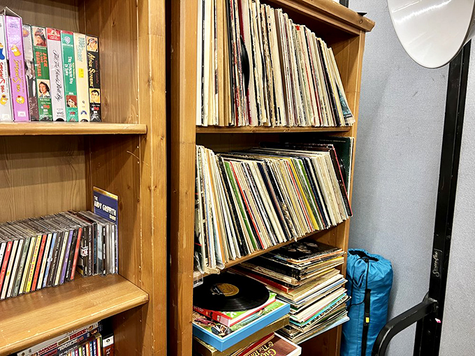 Vinyl records lean together like old friends, their album covers telling stories of musical eras gone by, waiting for the needle to drop once more.