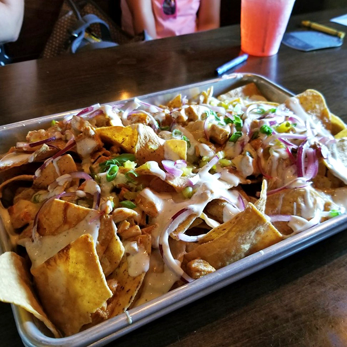 Loaded nachos that laugh in the face of portion control &ndash; a mountain of crispy chips, tender meat, and creamy sauce that demands to be shared.