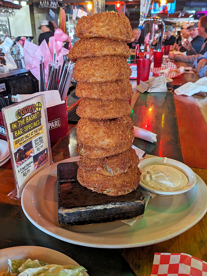 An engineering marvel of onion rings stacked higher than some Florida buildings. Whoever said "less is more" clearly never had these golden-battered beauties.