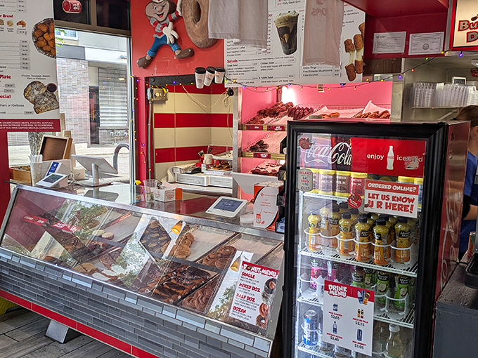 The donut command center&mdash;where magic happens behind glass cases filled with frosted, glazed, and cream-filled treasures waiting for their forever homes.