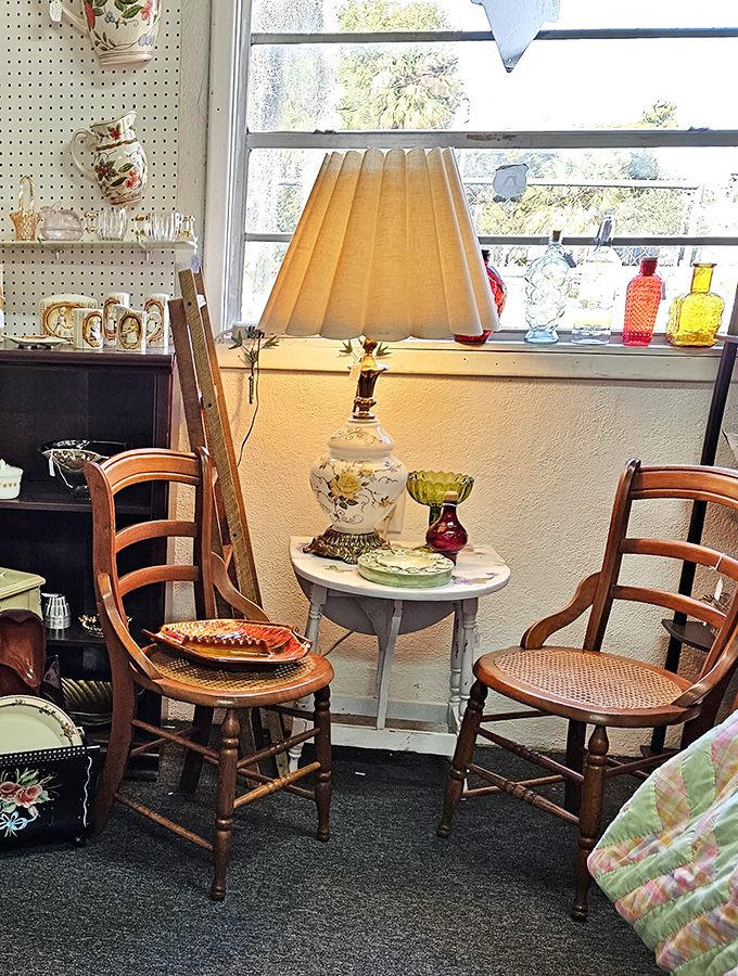 A perfectly staged vignette with cane chairs and a vintage lamp that's begging to become the reading nook you've always dreamed about.