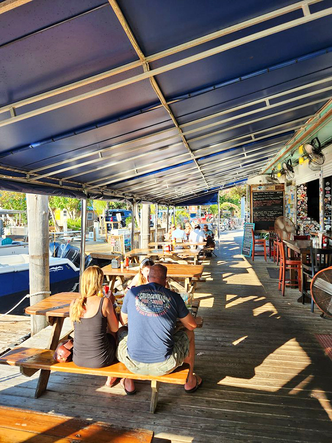 Outdoor dining where the dock meets the deck. The sunshine is complimentary, the sea breeze is bottomless, and the views come with every order.