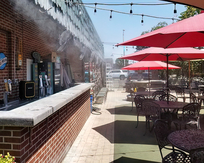 The outdoor patio offers a sunny escape with red umbrellas standing guard. Summer dining with a side of vitamin D.