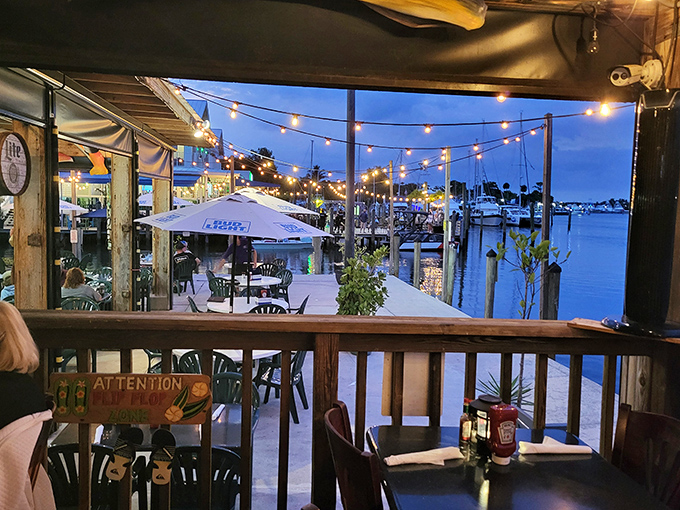 Twilight transforms Shrimper's waterfront into a string-lit wonderland where dinner stretches lazily into evening, and nobody minds one bit.
