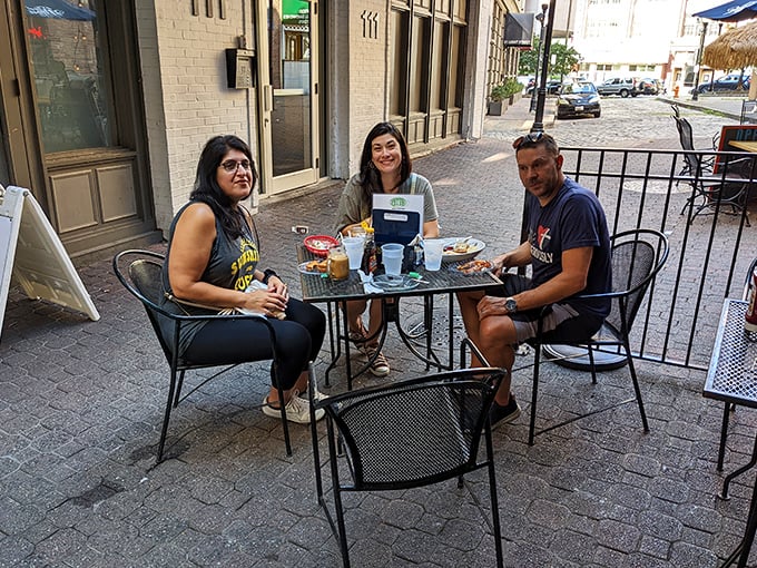 Outdoor tables offer urban al fresco dining where conversations flow as freely as the drinks, under the watchful gaze of city architecture. 