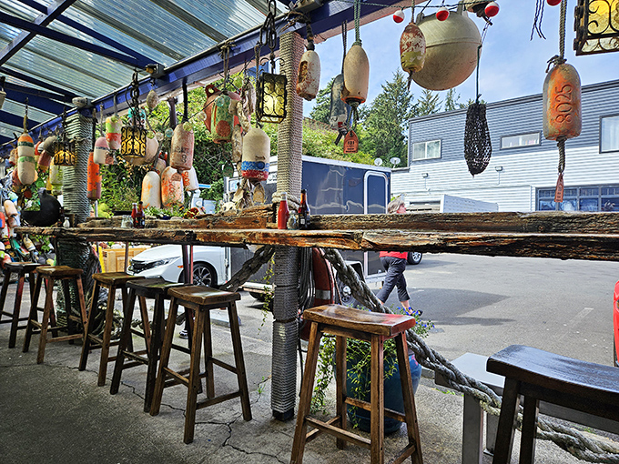 The outdoor seating area, where colorful buoys dangle like maritime Christmas ornaments, creating the perfect backdrop for your seafood selfies.