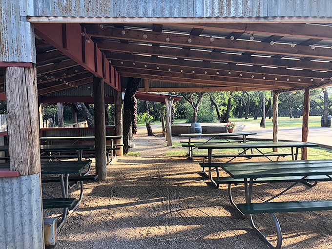 Outdoor dining under rustic metal roofing where the Texas breeze is as much a part of the meal as what's on your plate.