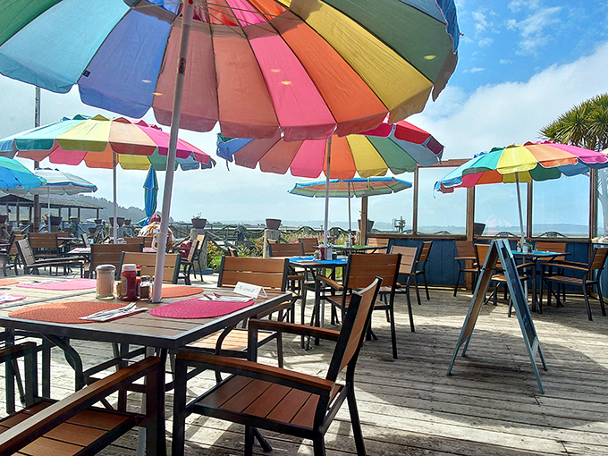 Colorful umbrellas create a festive atmosphere where every meal feels like a seaside vacation celebration.