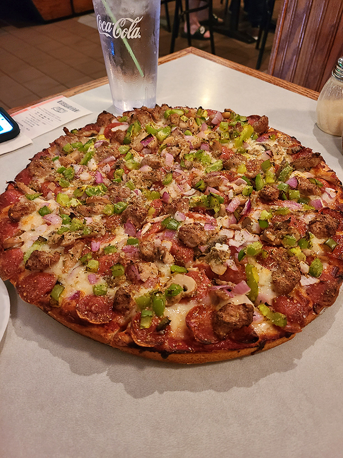 A pizza loaded with enough toppings to make your cardiologist nervous but your taste buds ecstatic. Worth every extra minute on the treadmill.