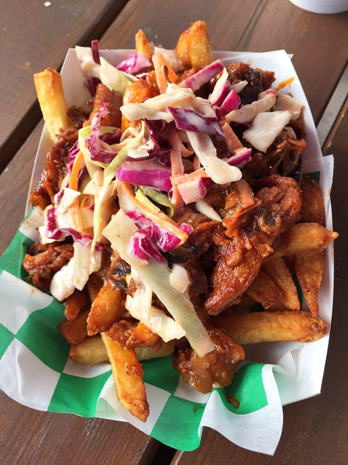 Loaded fries that require both a fork and dedication. That slaw adds a fresh crunch to balance the savory symphony below.