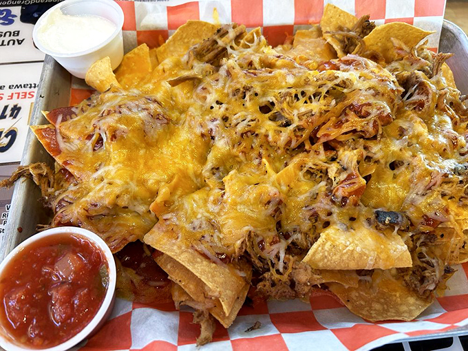 Nachos that laugh in the face of restraint, where every chip is a treasure map leading to pulled pork gold and cheese rivers flowing freely.