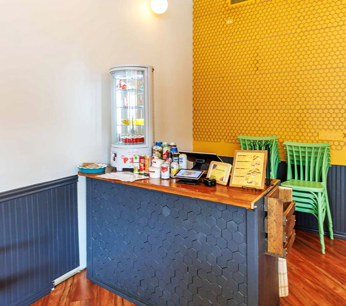 The honeycomb-patterned counter and sunny yellow wall create a visual reminder of what makes this chicken so special&mdash;it's all about the honey, honey.