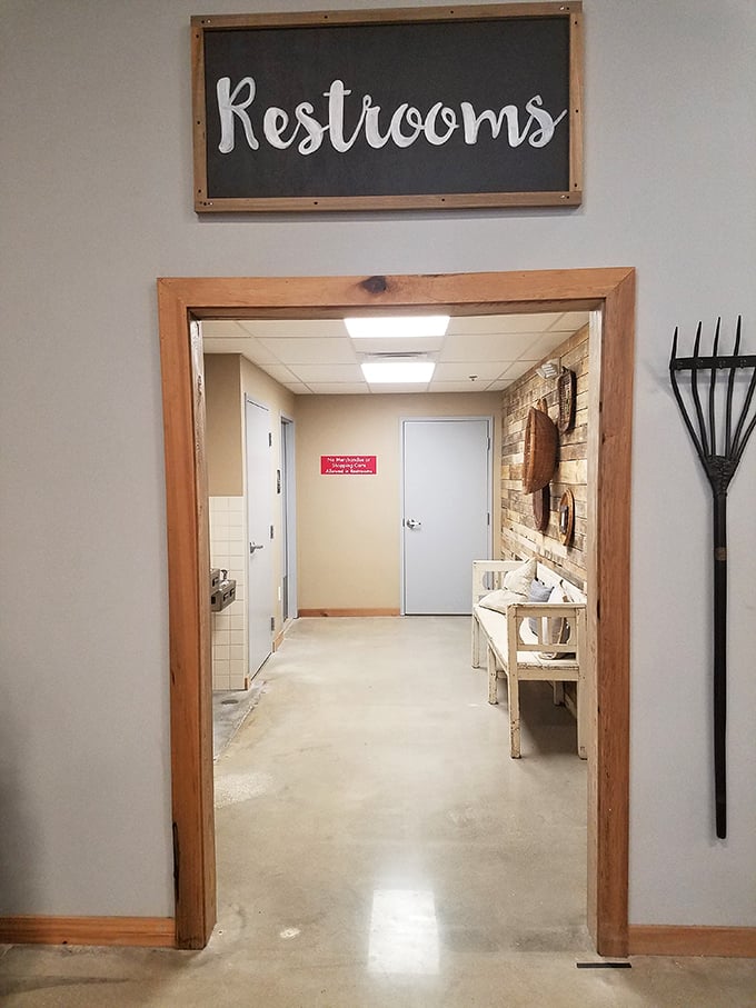 Even the restroom entrance shows attention to detail, with rustic-chic signage and thoughtful touches like a vintage garden rake.