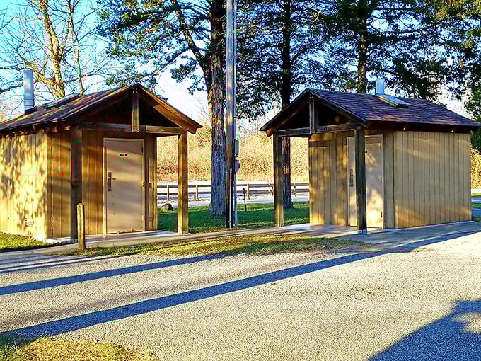 Even the practical facilities maintain rustic charm, with wooden shelters housing modern conveniences for visitor comfort.