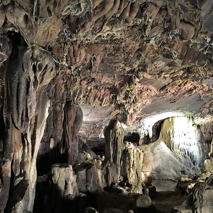 Cathedral-like chambers where stalactites and stalagmites reach toward each other in a geological dance measured in centuries.