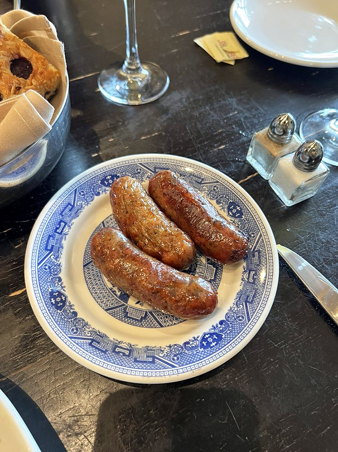 Sausages served on blue willow china&mdash;a delightful clash of rustic and refined. Comfort food dressed for a special occasion.