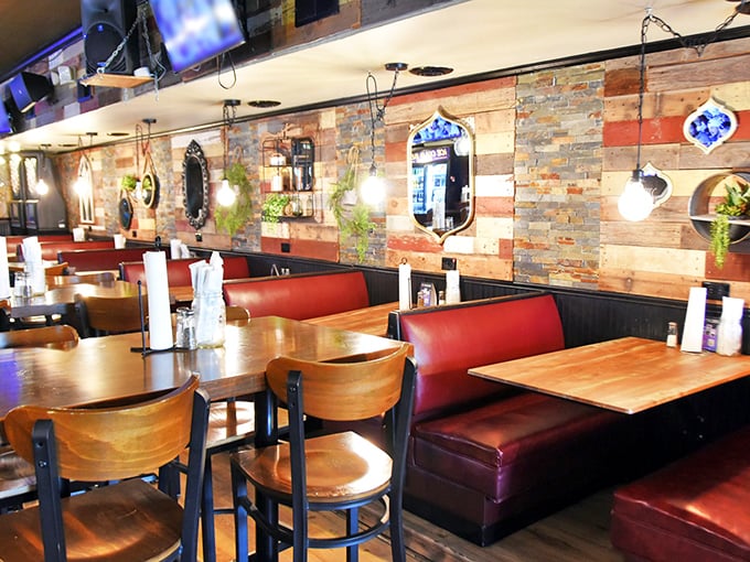 Red booths against rustic wood walls create the perfect backdrop for food-induced happiness. Notice how there's just enough space between tables for privacy but not secrets.