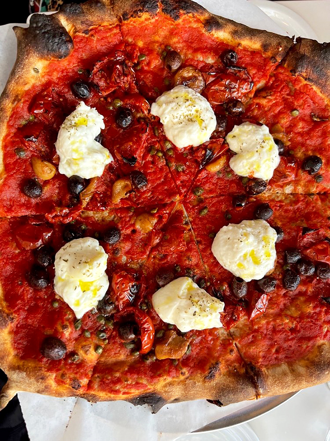 She Wolf brings burrata and garlic confit together in holy pizza matrimony &ndash; bellissimo!
