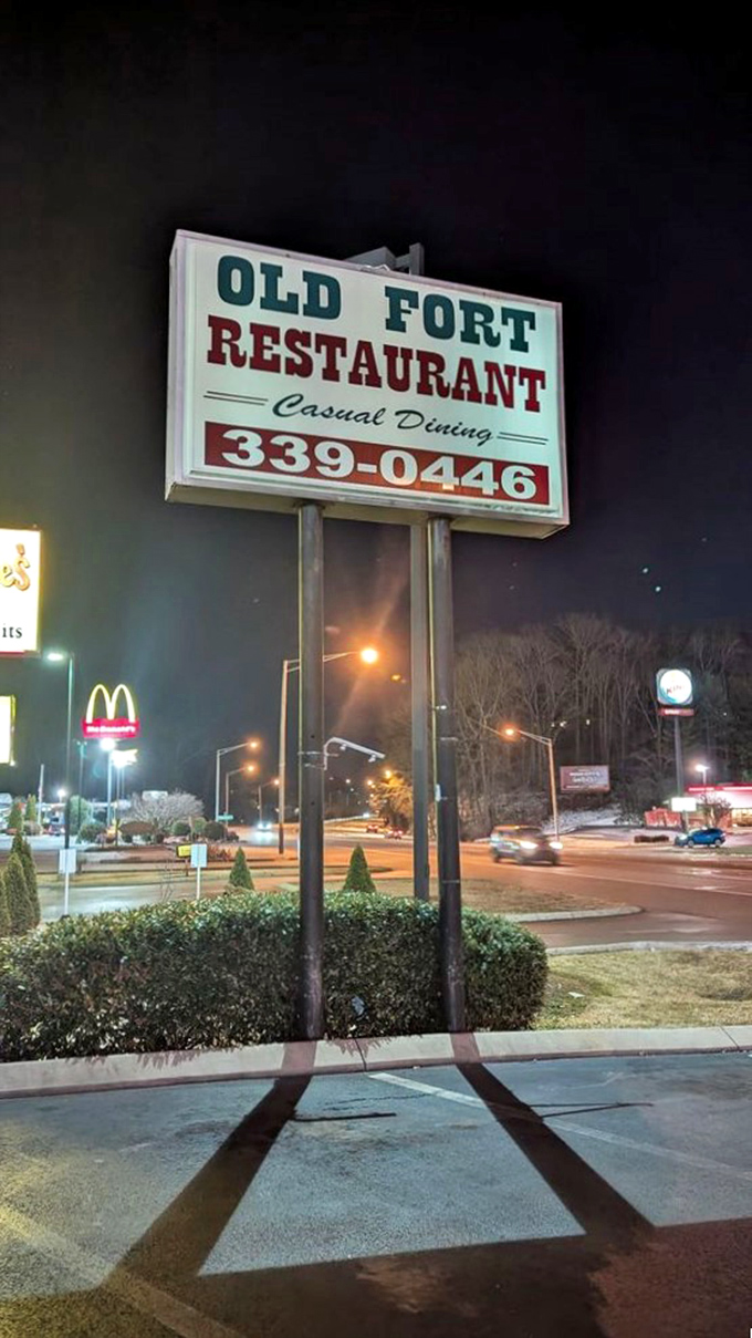 The Old Fort sign stands tall against the night sky, a beacon of hope for hungry travelers and locals craving honest-to-goodness cooking.