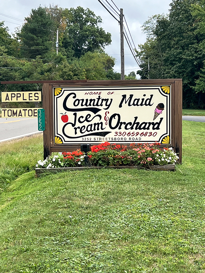 The roadside sign blooming with flowers&mdash;nature's way of highlighting the sweetest detour you'll make all day.