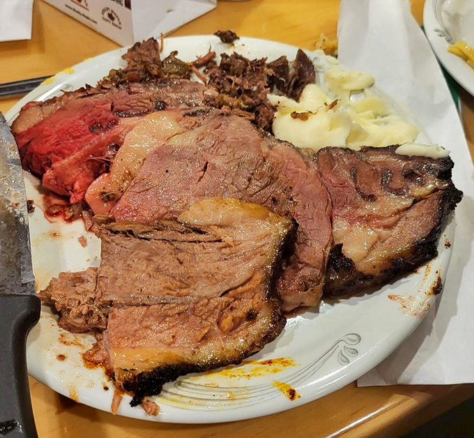 A hearty plate of juicy prime rib, served with a side of creamy mashed potatoes, looks like the ultimate comfort food feast.