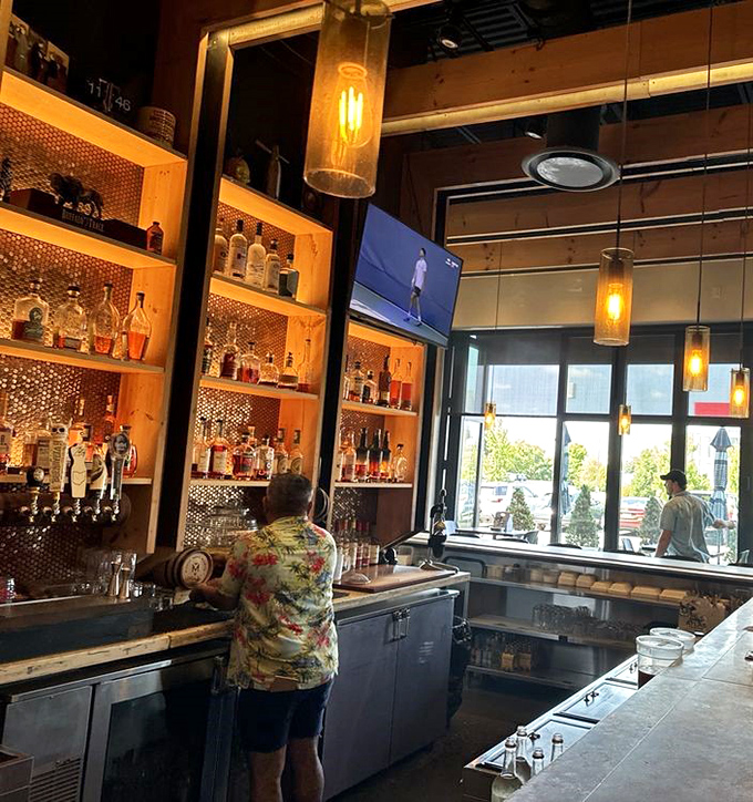 Behind every great bar is someone who knows exactly what you need before you do. The warm wood and copper backdrop sets the stage for liquid artistry.