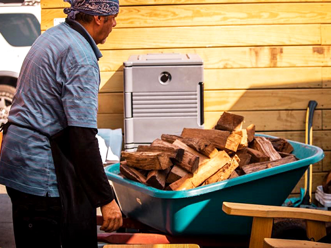The unsung heroes of barbecue: those who tend the wood. Like a pitmaster alchemist, transforming simple logs into the foundation of flavor.