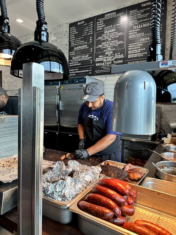 The pitmaster at work, tending to smoky treasures with the focus of a surgeon and artist combined.