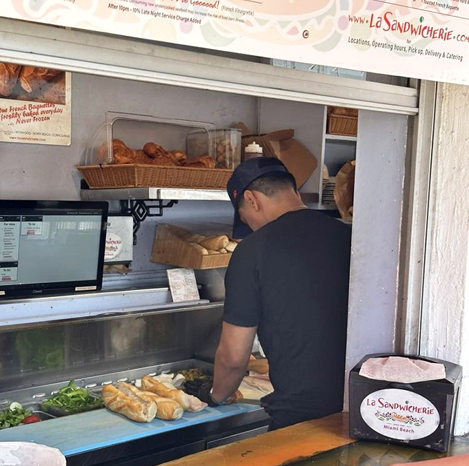Fresh bread being prepped for its destiny. In the hands of these sandwich artisans, simple ingredients become legendary meals.