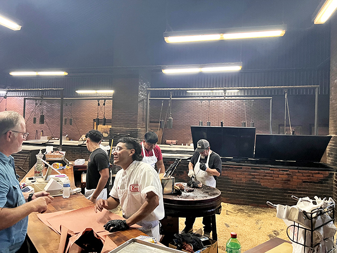 The pit masters work with the focus of artists, each movement deliberate and practiced, turning raw meat into edible masterpieces.